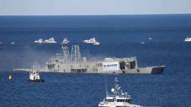 HMAS Adelaide goes under after dolphin display delays scuttling
