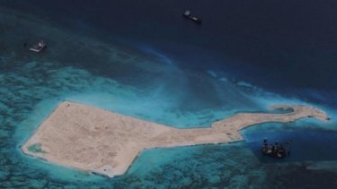 Photos reveal China building on reefs in disputed waters