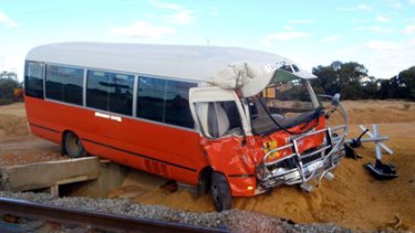 Children, driver escape as train hits school bus