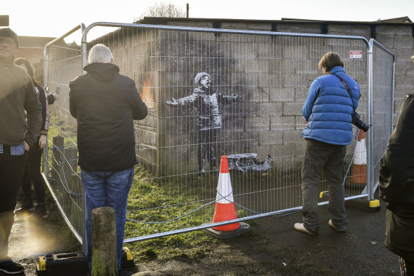 Banksy mural on garage in Wales sells for six-figure sum