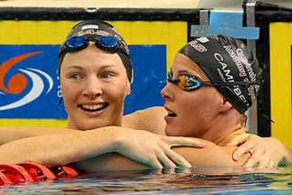 Winning swim sisters muzzle embarrassing dad