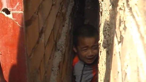 Boy gets stuck between two walls