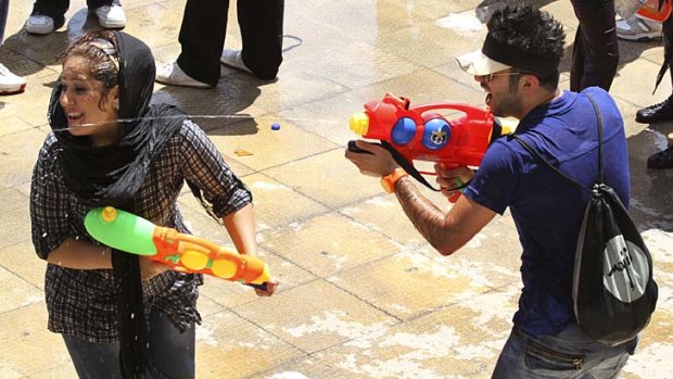 Young Iranians cop a spray over public water fights