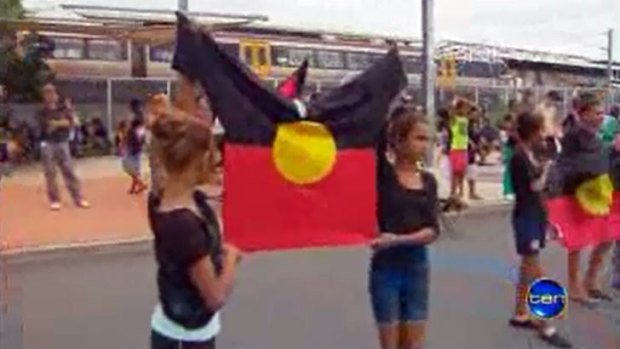 Mourners march through Logan