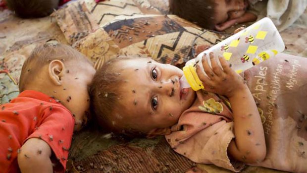 Eight children, one cooking pot, no food