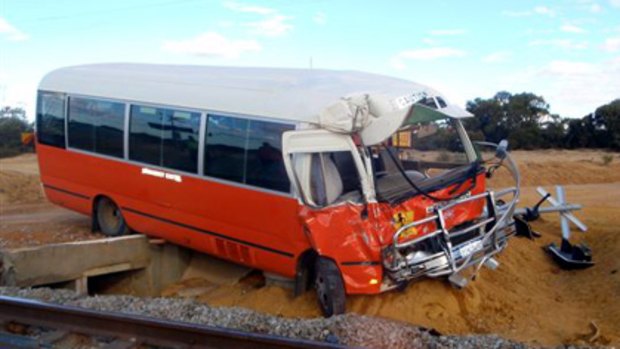 Children, driver escape as train hits school bus
