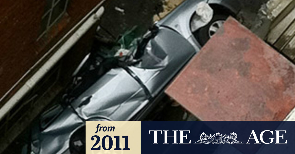 Woman survives as car falls from city building