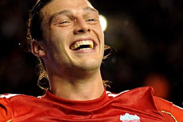 Carroll scores double as Liverpool hits City Champions League hopes