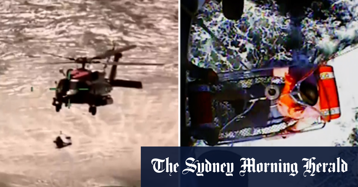 Video: Two people from sunken boat fend off sharks during Coast Guard ...