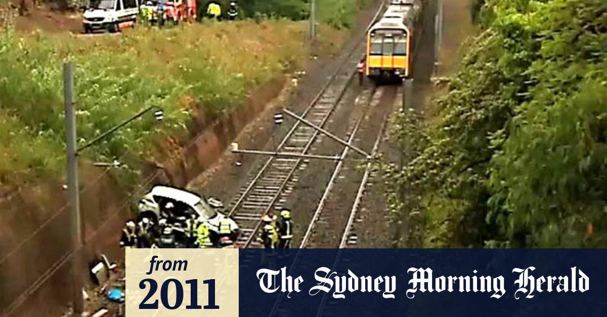 Video: Car crashes on to train tracks