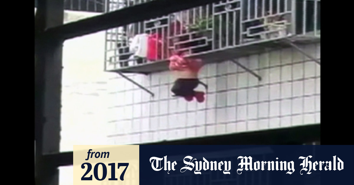 Video: Workers save girl hanging from building