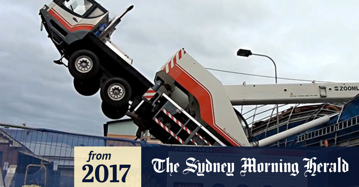 Video: Man falls as crane topples