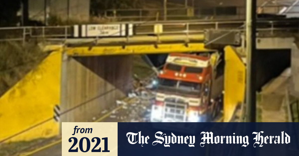 Video: Truck driver stuck under bridge in Queensland