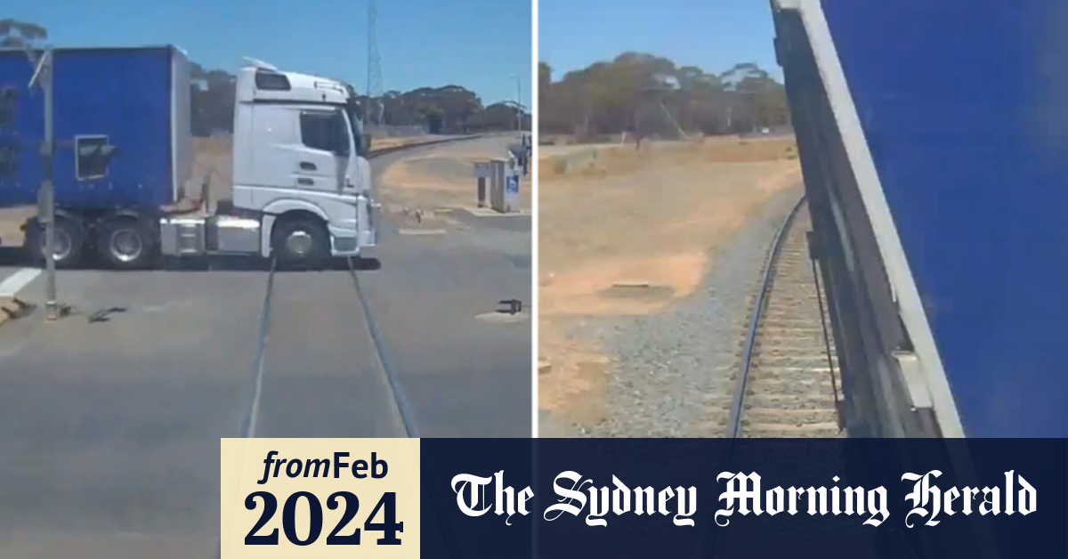 Video: Heart-stopping moment freight train barely misses truck