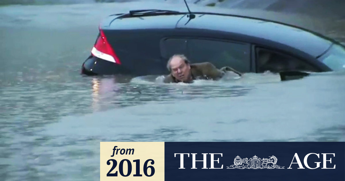 Video: TV reporter helps man caught in Houston flood