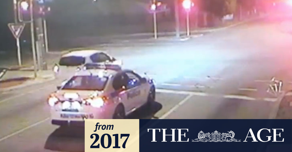 Video: Driver runs red light in front of police