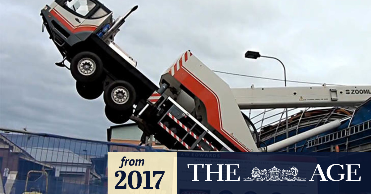 Video: Man falls as crane topples