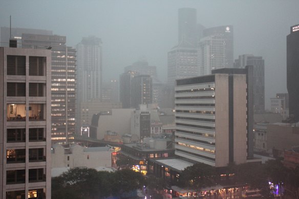Darkness rolls over Brisbane in brief-but-mighty storm