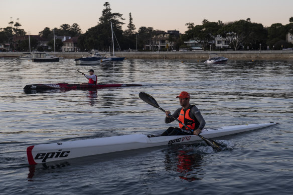 Corporate high-fliers make a splash on the harbour in their surf skis