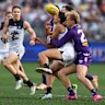 Karl Worner of the Dockers tackles Ashton Moir of the Blues during the round 21 AFL match between the Fremantle Dockers and Carlton Blues at Optus Stadium on August 03, 2025 in Perth, Australia.
