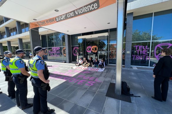 Extinction Rebellion glue hands to floor at Dumas House Perth to ...