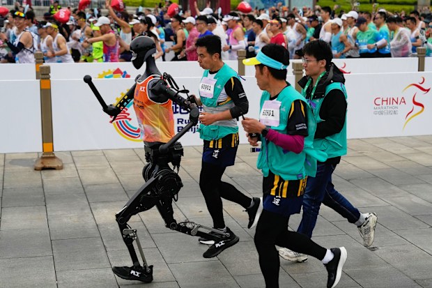 AI technology: China’s first robot marathon runners trip, emit smoke ...