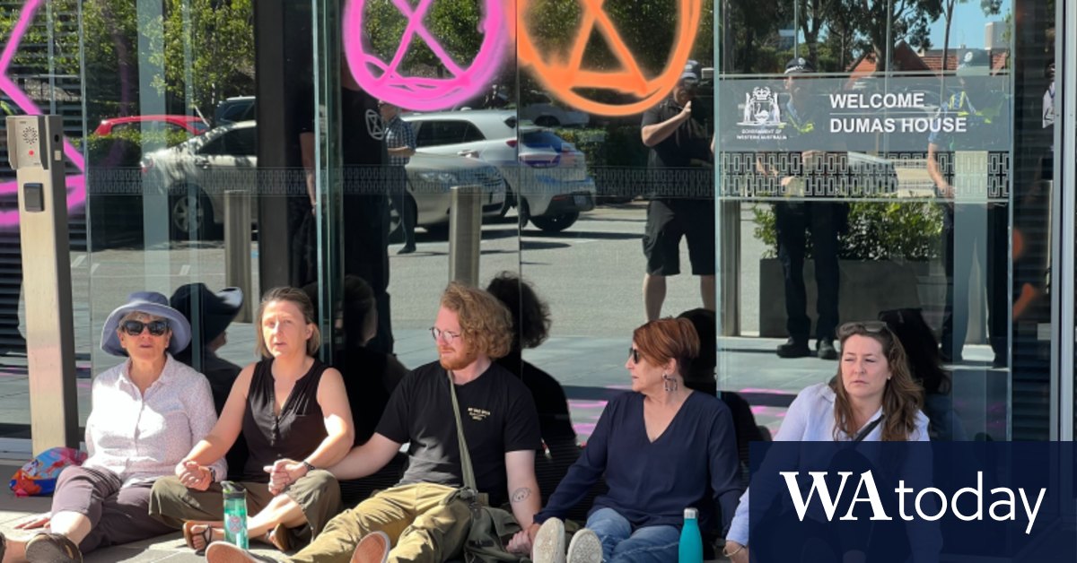 Extinction Rebellion glue hands to floor at Dumas House Perth to ...