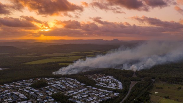 Sunshine Coast motorway reopened as bushfire threat eases slightly