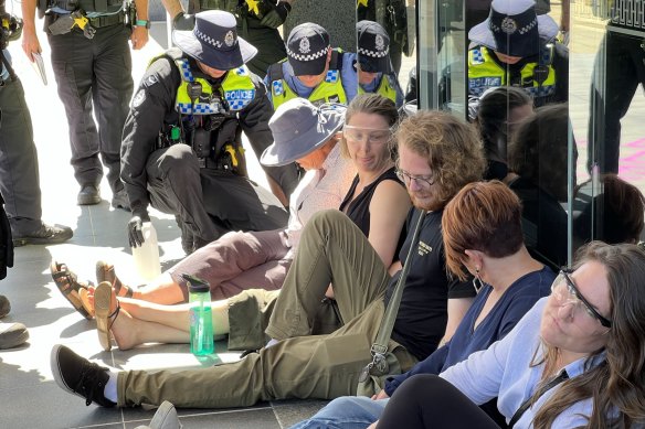 Extinction Rebellion glue hands to floor at Dumas House Perth to ...
