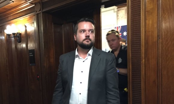 Police escort Jared Cassidy from council chambers