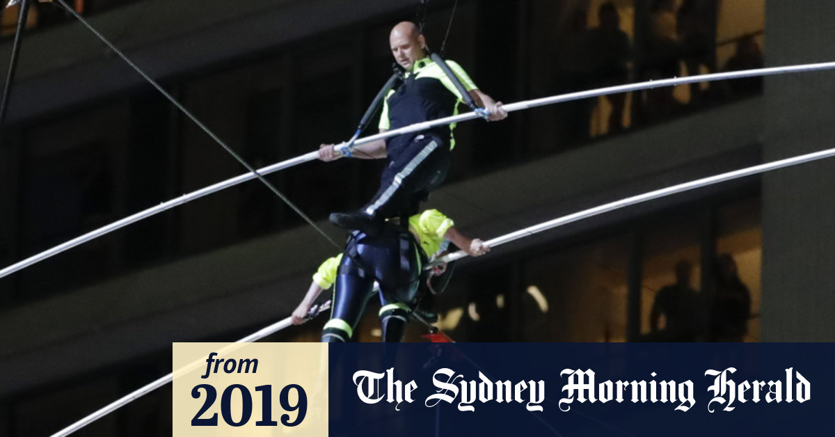 High-wire walkers safely cross Times Square 25 storeys up