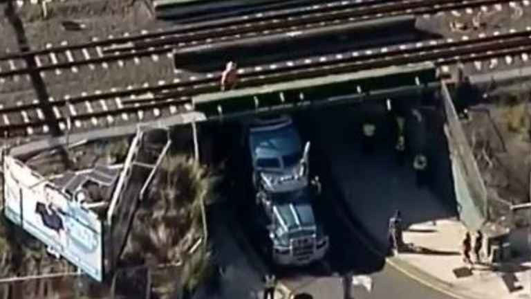 Traffic and train delays after truck stuck under bridge in Milton