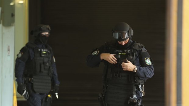 Riot police carry out raids at two western Sydney addresses
