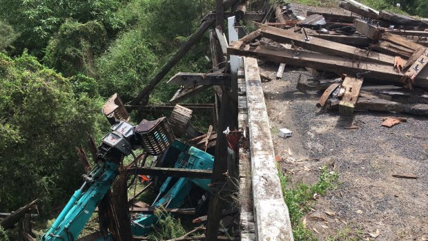 Excavator plunges as Qld bridge being dismantled collapses
