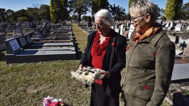 Family place medals and flowers on grave of heroine WWI nurse Alice Cashin