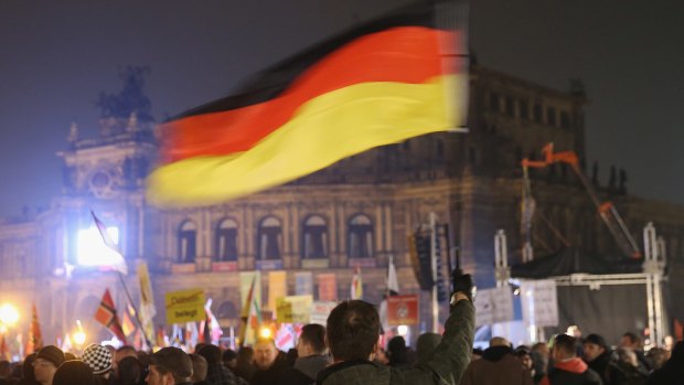 German anti-Islam Pegida protest swells, as refugee shelters burn