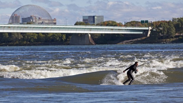 Surfing the river rapids in Montreal, Canada