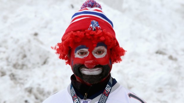 Fans cheer New England Patriots atop Boston snow piles at Super Bowl parade