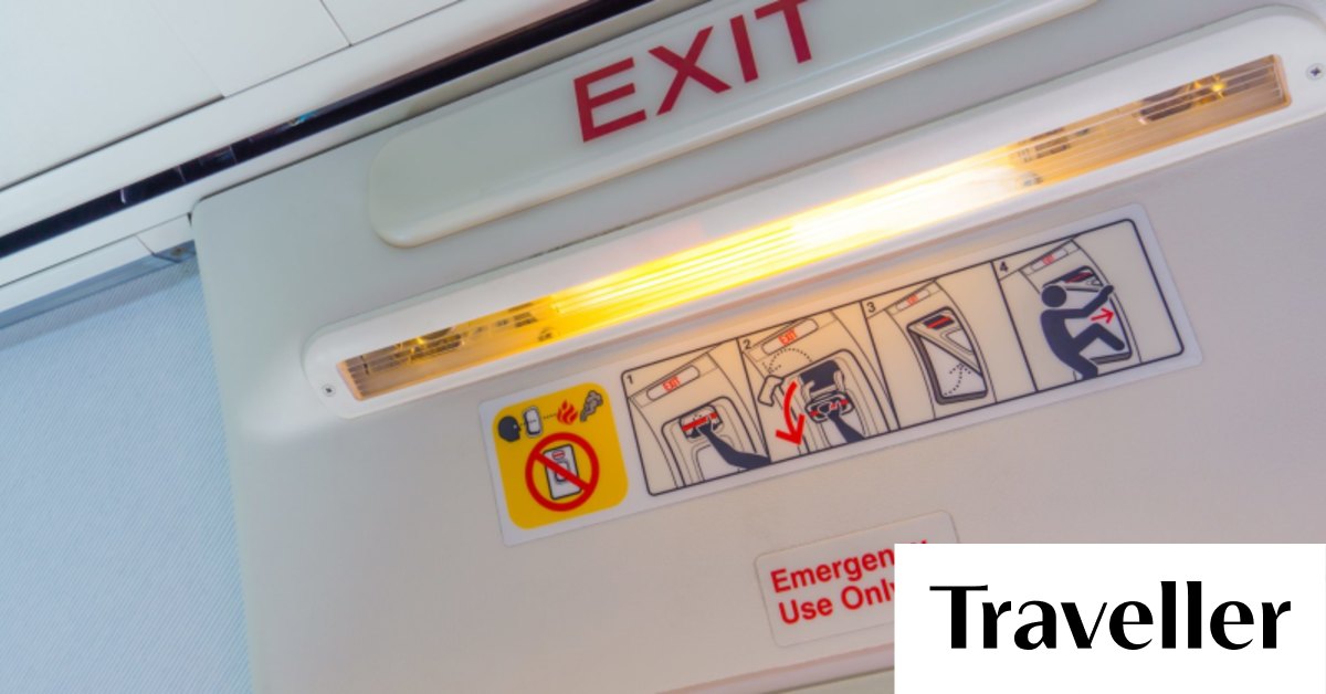 Why do some aircraft emergency exit doors have red tape over the window?