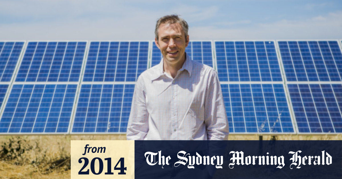 Luke Osborne with a bank of solar panels.
