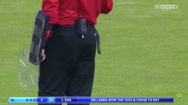 Umpire Bruce Oxenford tries out protective equipment during England v ...