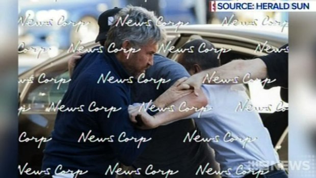 Packer fight photographer Brendan Beirne hands pictures to police