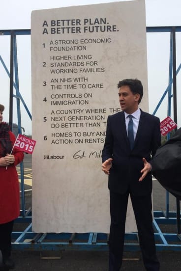 Ed Miliband poses with policy 'tombstone'