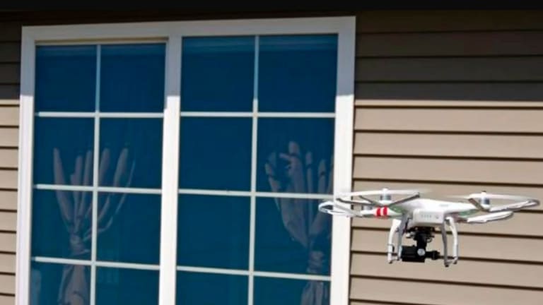 Woman comes eye to eye with camouflaged drone peeping in her bedroom window
