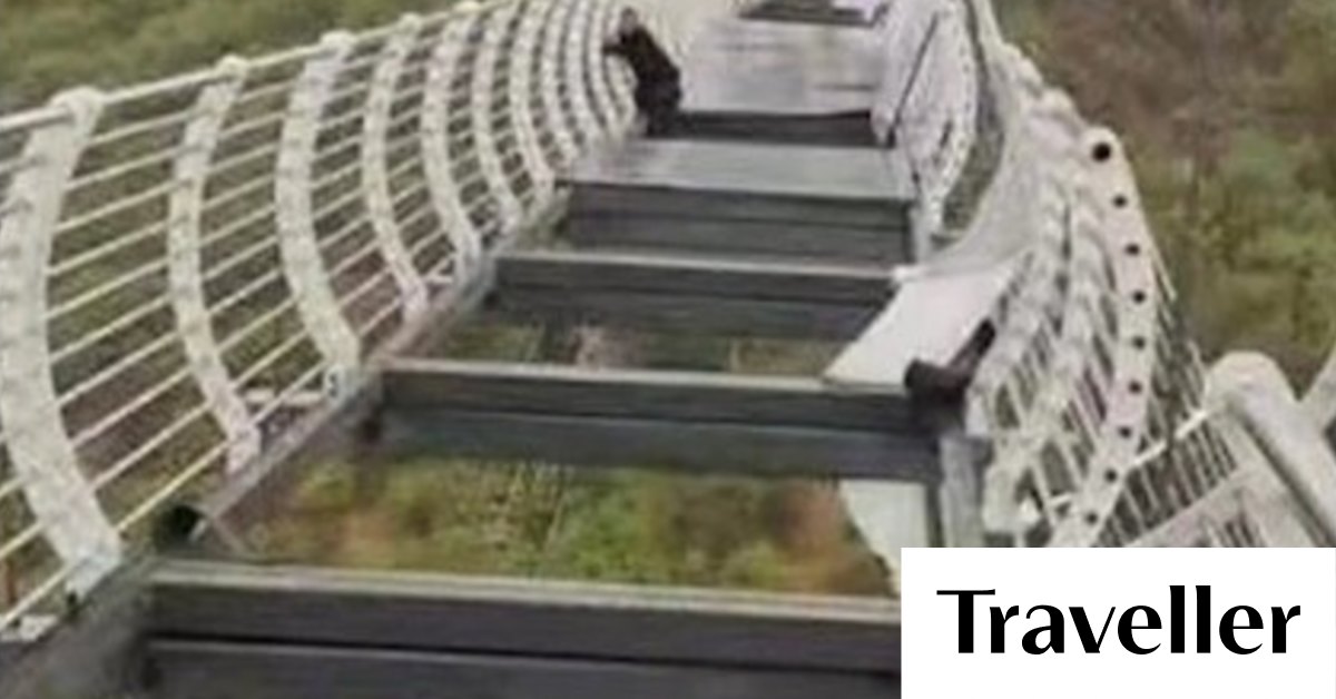 Glass bridge in China breaks, trapping tourist 100m above ground