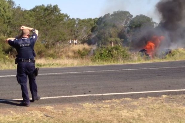 Grass fire destroys police car stopped in long grass