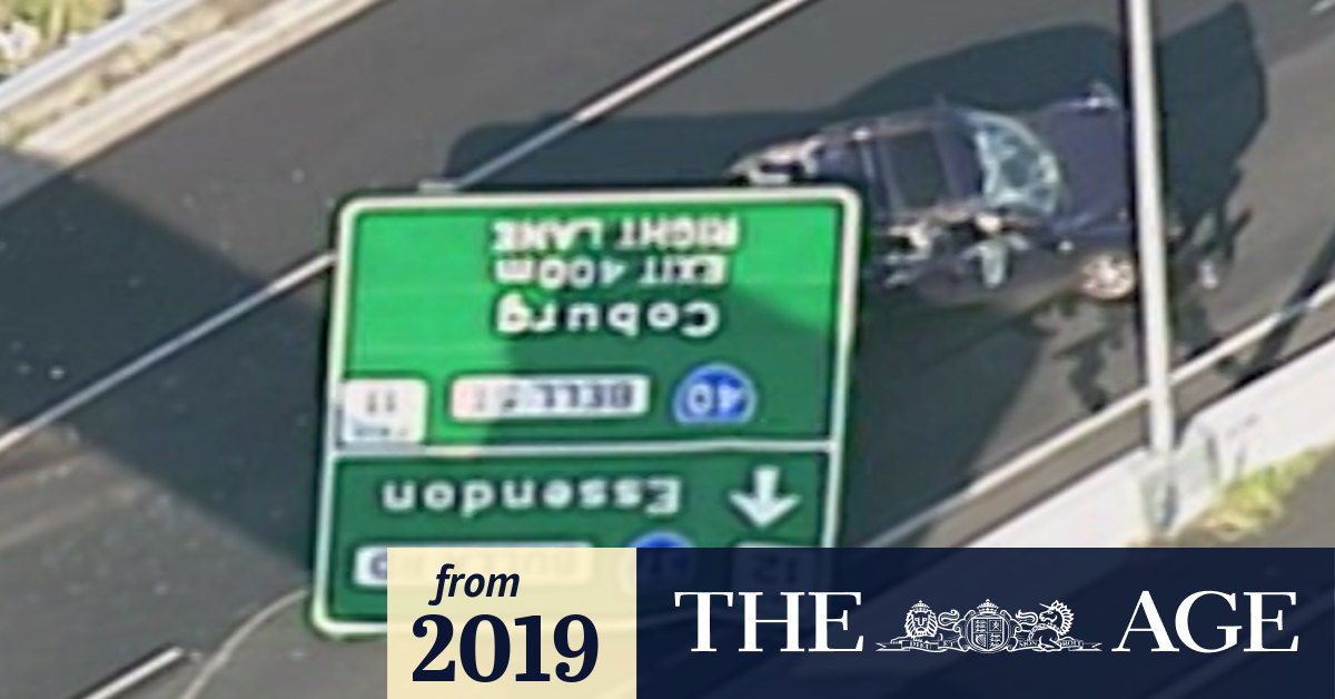 Sign fall: Tullamarine Freeway sign falls and crushes car, injuring woman