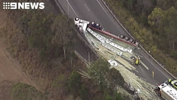 M1 traffic at standstill after truck rolls at Gateway Motorway on-ramp