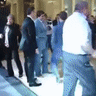 Dmitry Medvedev, next to the man in a white shirt, dancing at a university reunion. 