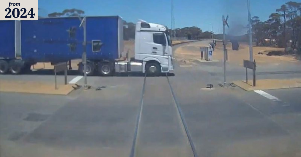 Watch the heart-stopping moment a freight train barely misses truck